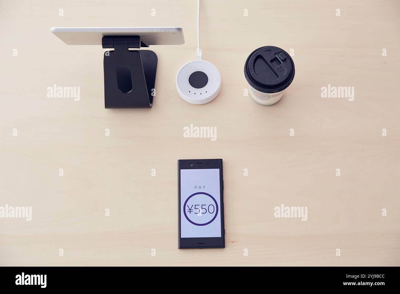 Cashless payment terminal and smartphone Stock Photo - Alamy