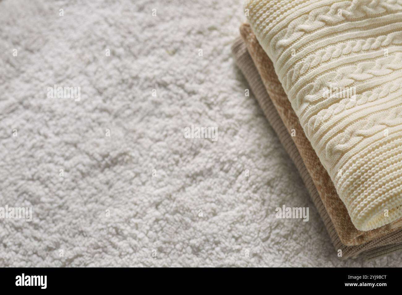 Three layers of jumpers on white boa material Stock Photo - Alamy