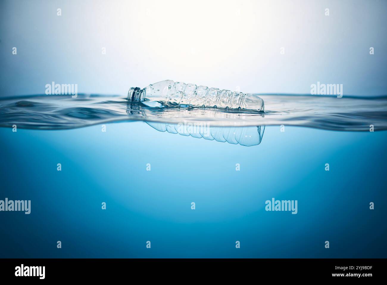 Empty plastic bottles floating on water Stock Photo - Alamy