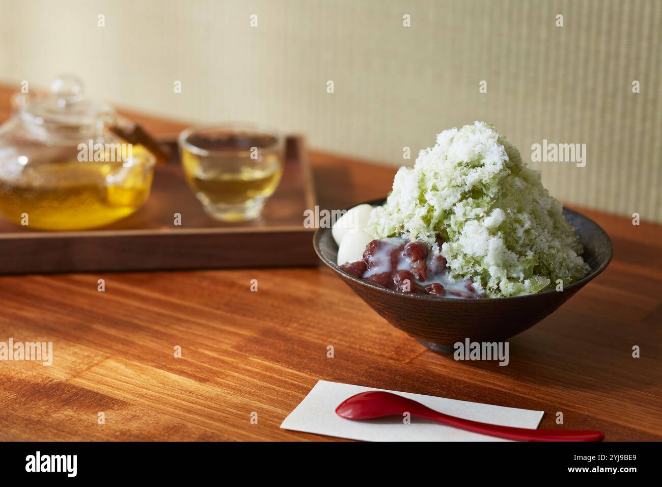 Shaved ice with glass tea utensils on a tray and shaved ice with ...