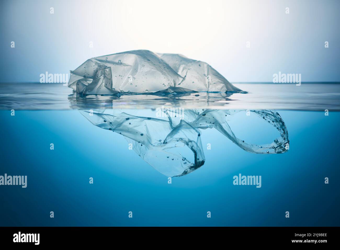 Plastic bag floating on water Stock Photo - Alamy