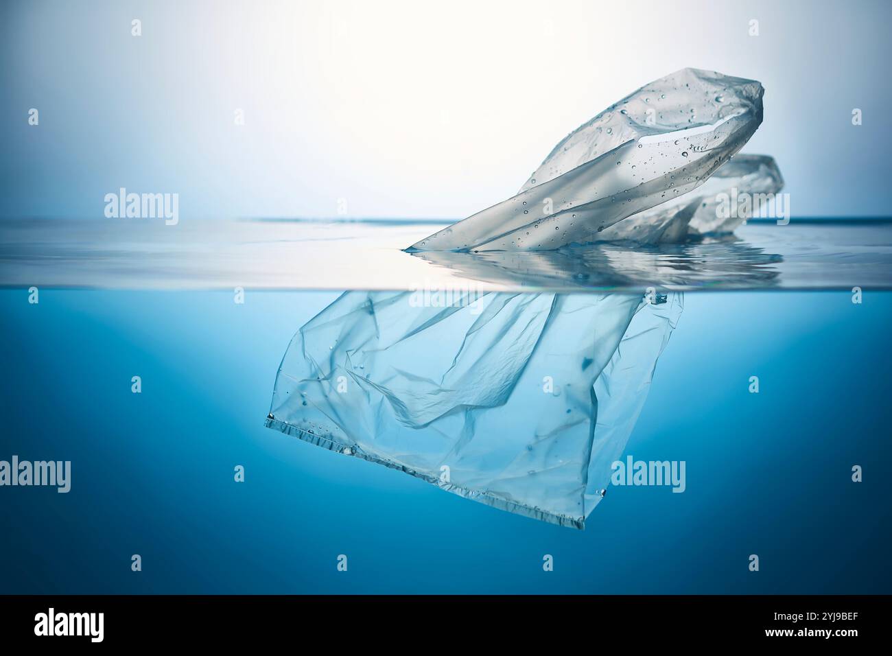Plastic bag floating on water Stock Photo - Alamy