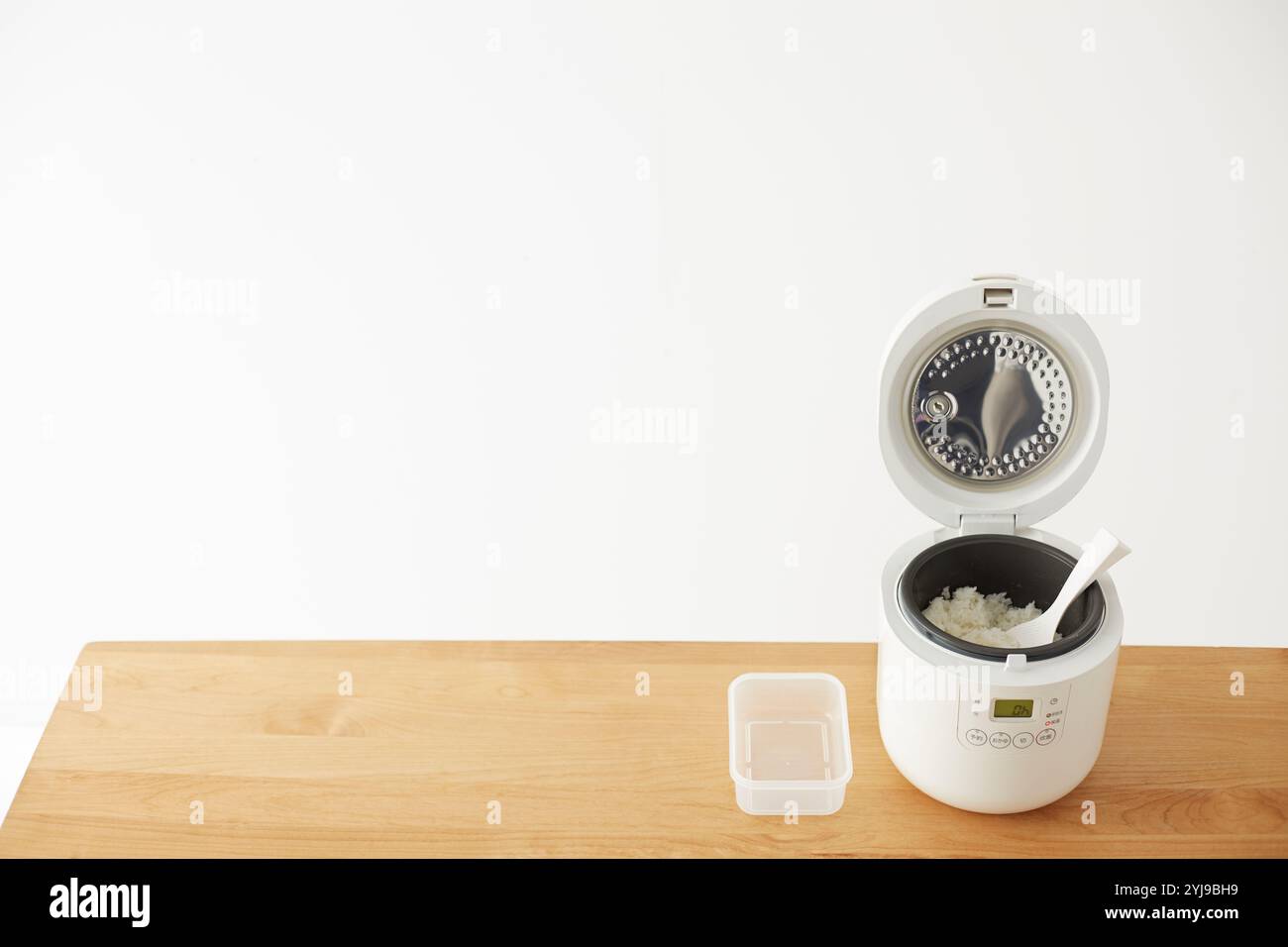 Empty Tupperware and rice cooker with white rice Stock Photo - Alamy