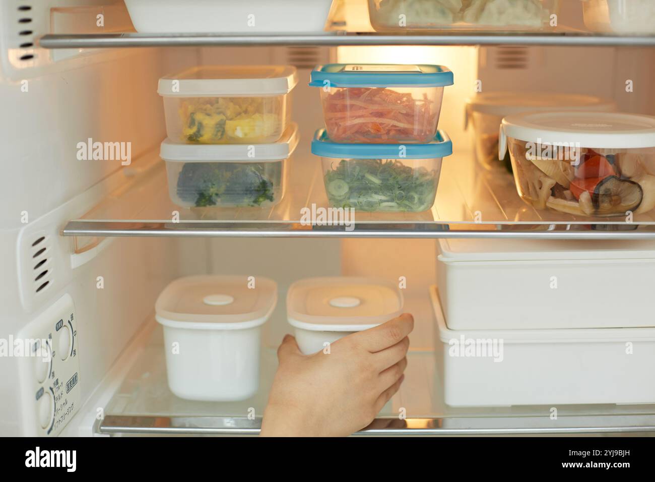 People's hands taking Tupperware out of the fridge Stock Photo - Alamy