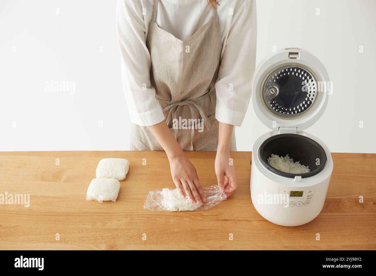 Woman dividing white rice into small portions in plastic wrap Stock ...