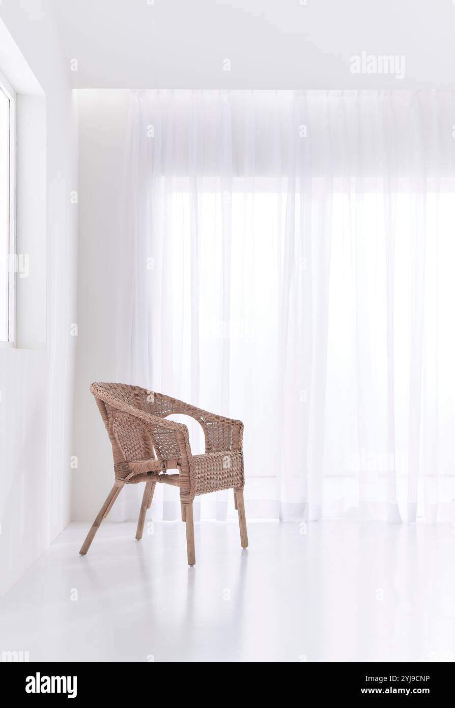 Rattan chair in white space Stock Photo - Alamy