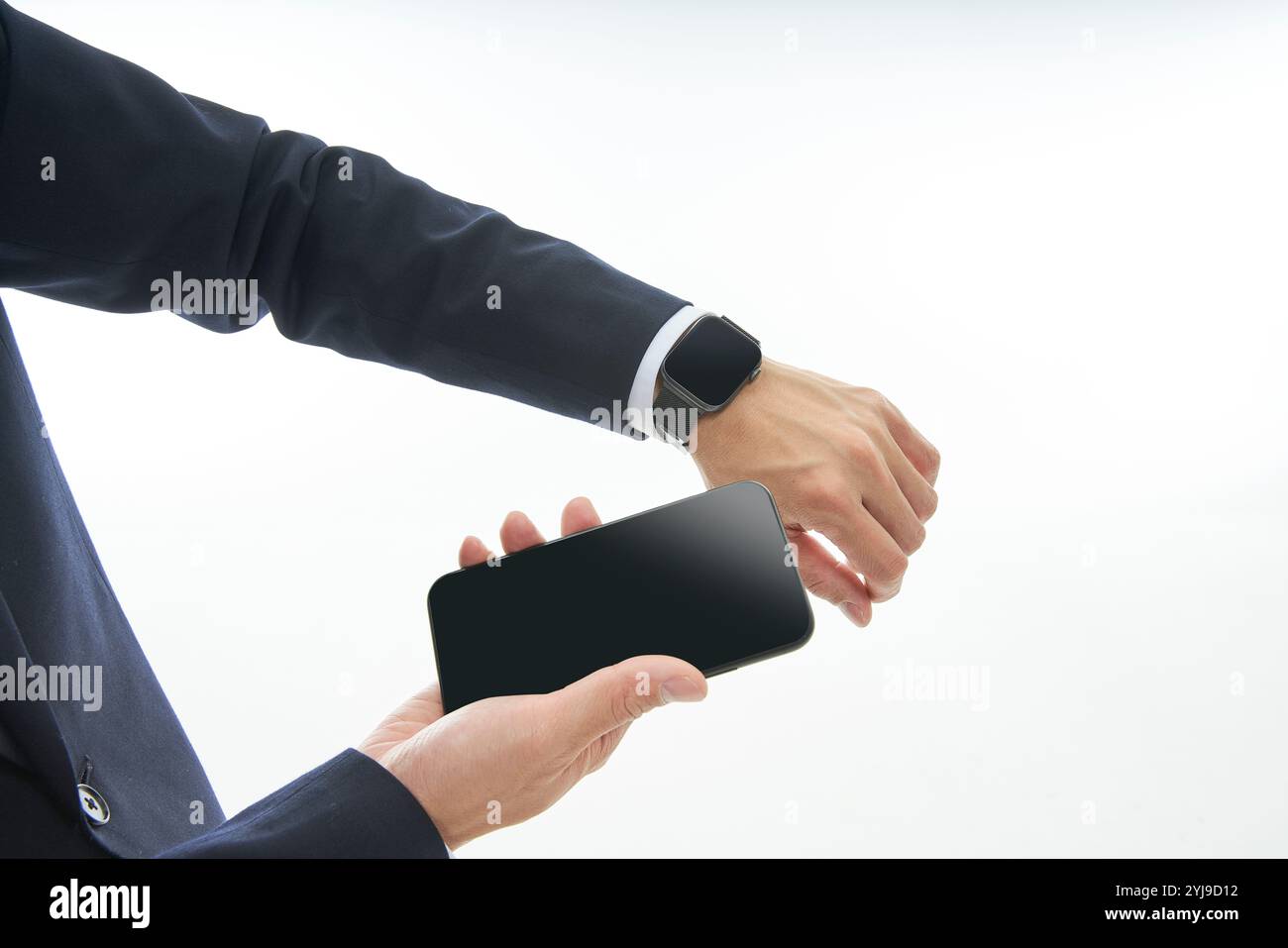 Smartwatch and businessman's hand holding a smartwatch and smartphone ...