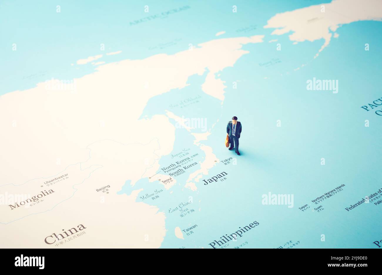 Miniature doll standing by Japan on world map Stock Photo - Alamy