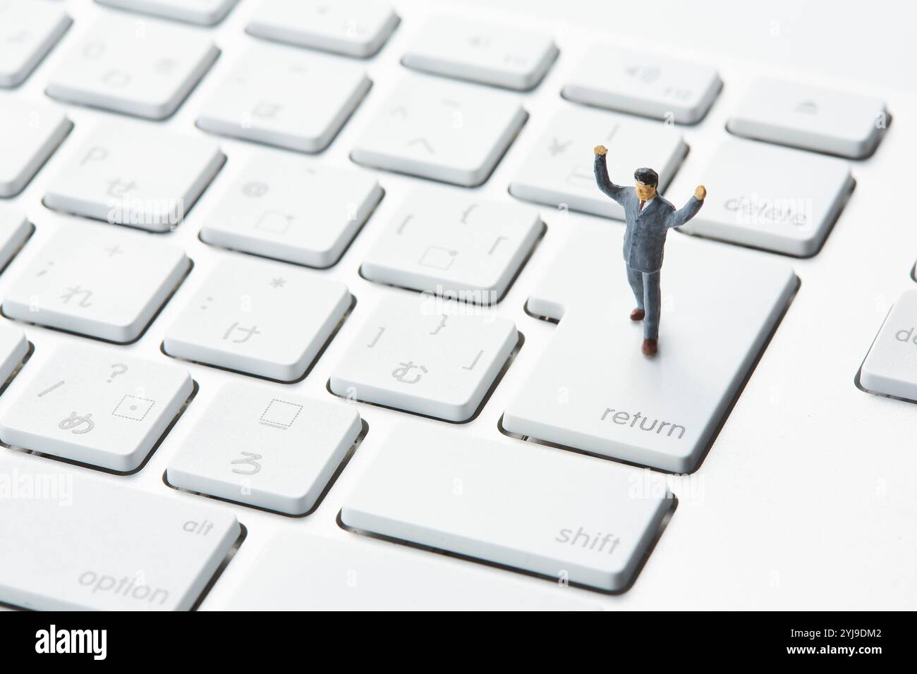 Miniature dolls spreading their hands on the keyboard Stock Photo - Alamy