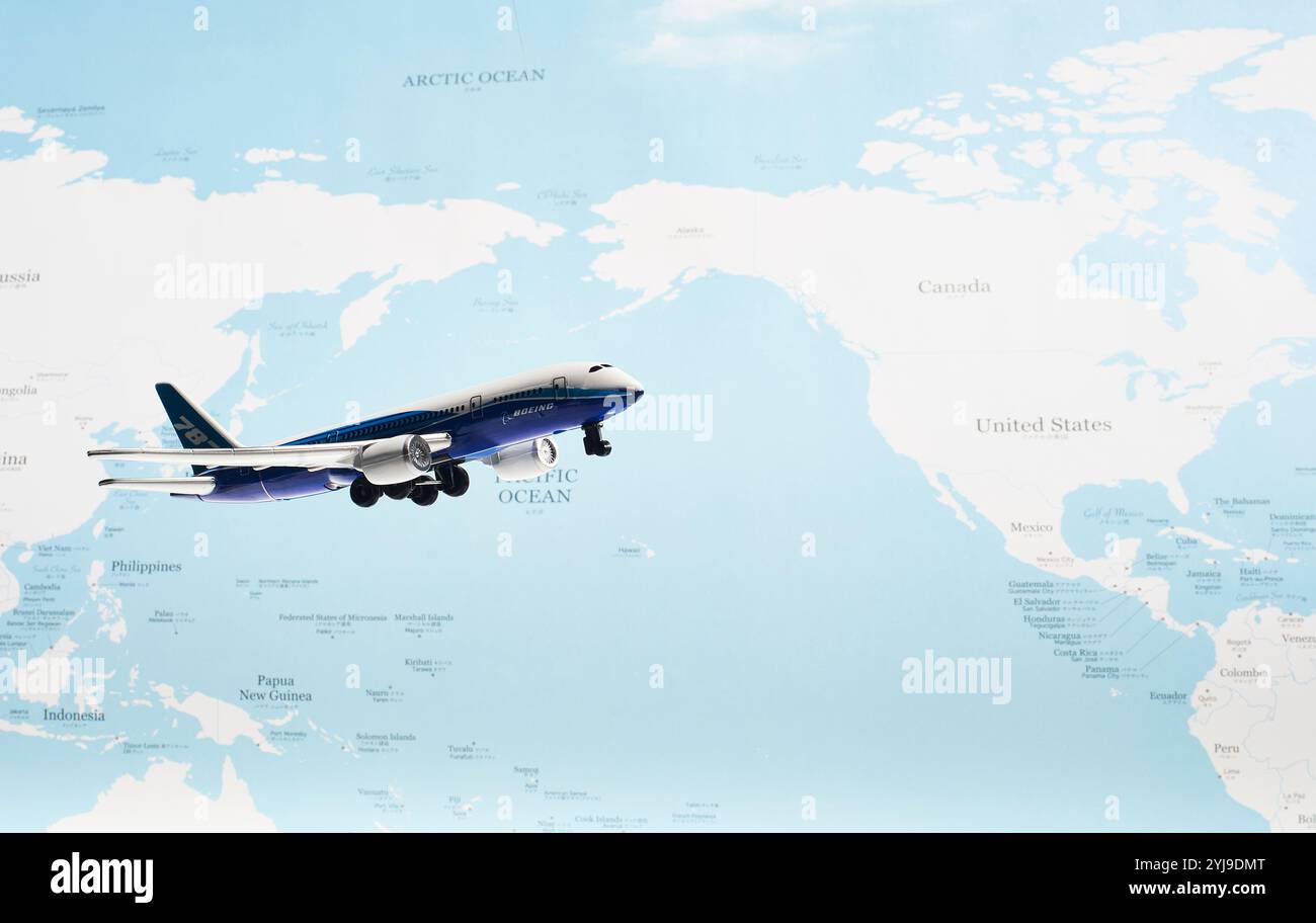 Aeroplane flying with world map in background Stock Photo - Alamy
