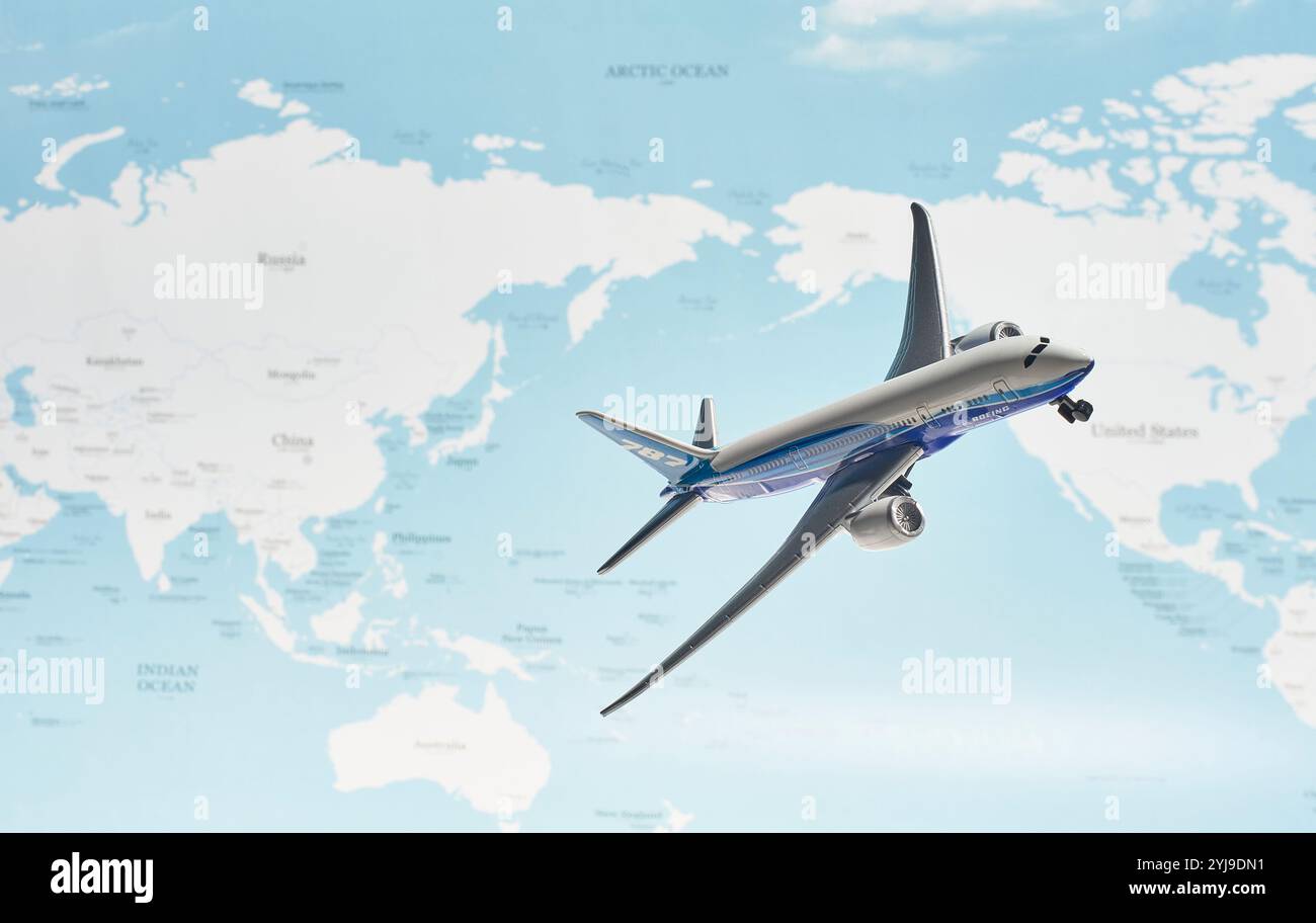 Aeroplane flying with world map in background Stock Photo - Alamy
