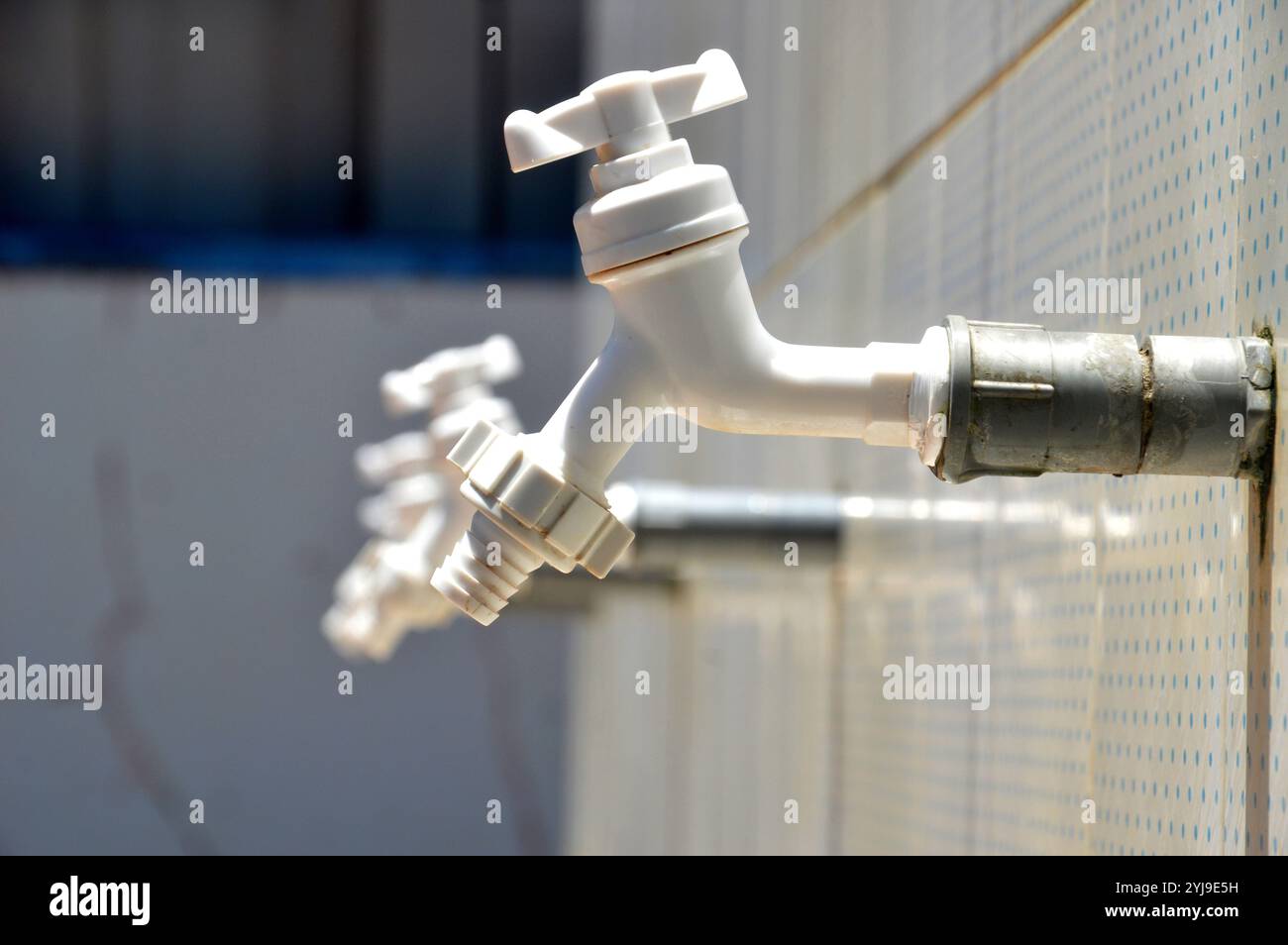 lined plastic white water faucets for ablution Stock Photo - Alamy