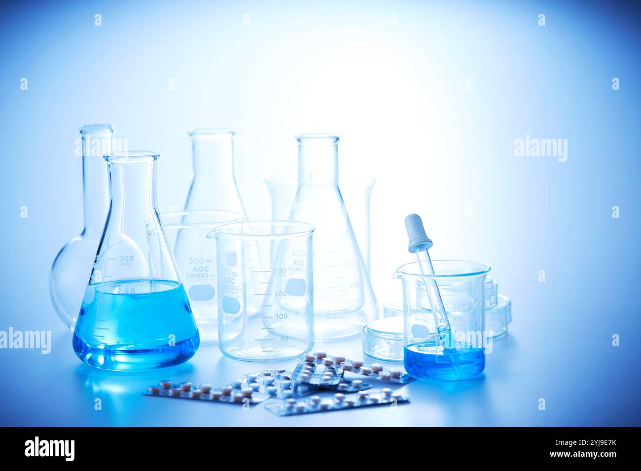 Multiple flasks and beakers, petri dishes, dropper and multiple tablets ...