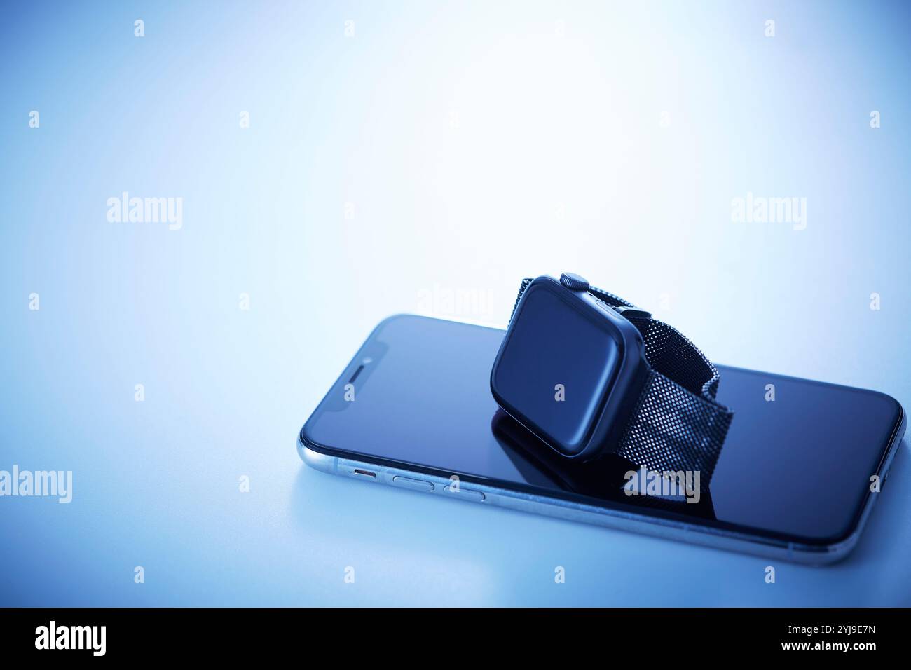 Smartphone and smartwatch on table Stock Photo - Alamy