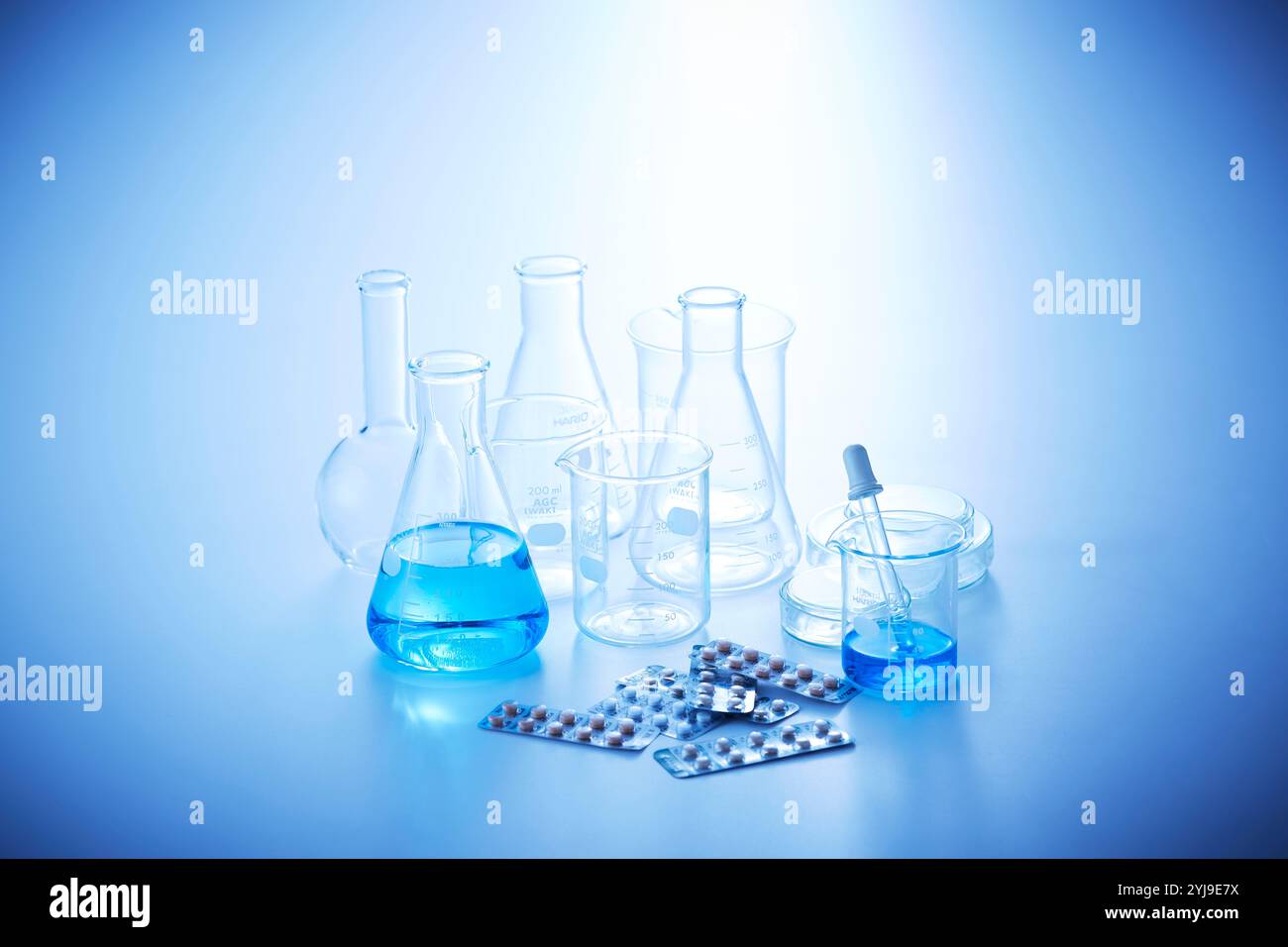 Multiple flasks and beakers, petri dishes, dropper and multiple tablets ...
