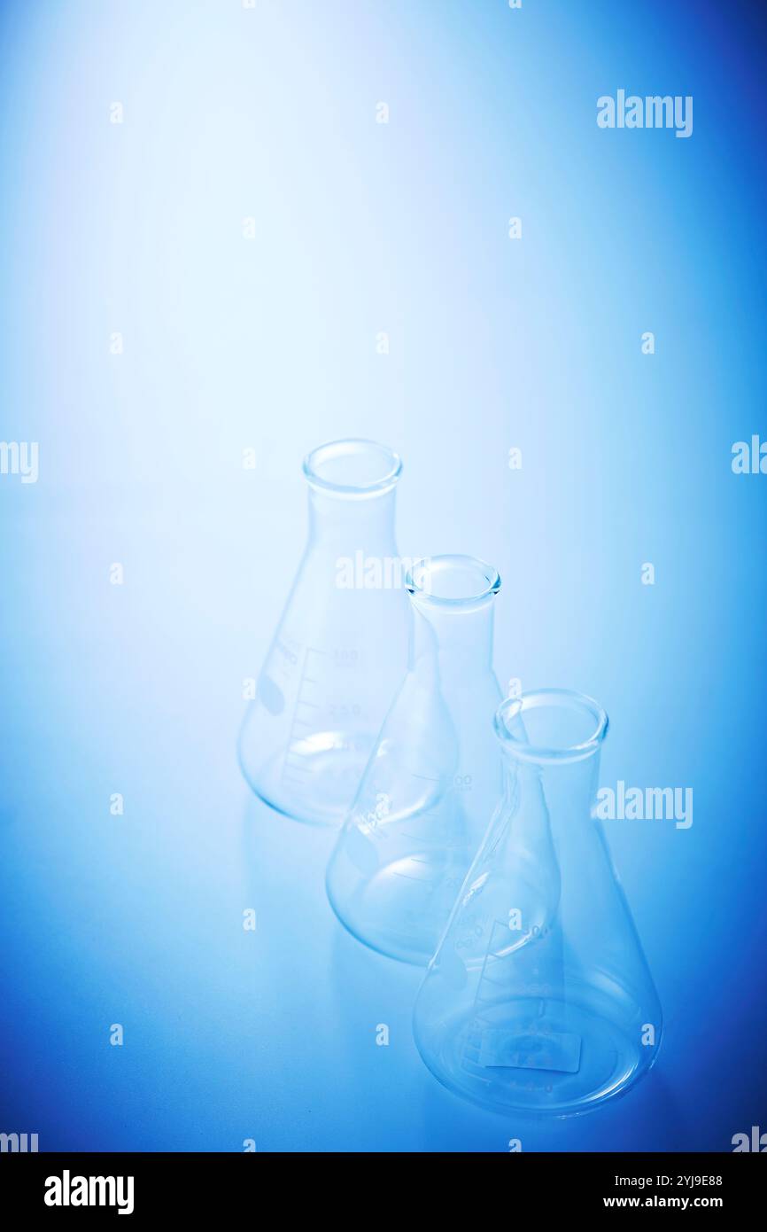 Three side-by-side triangular flasks Stock Photo - Alamy