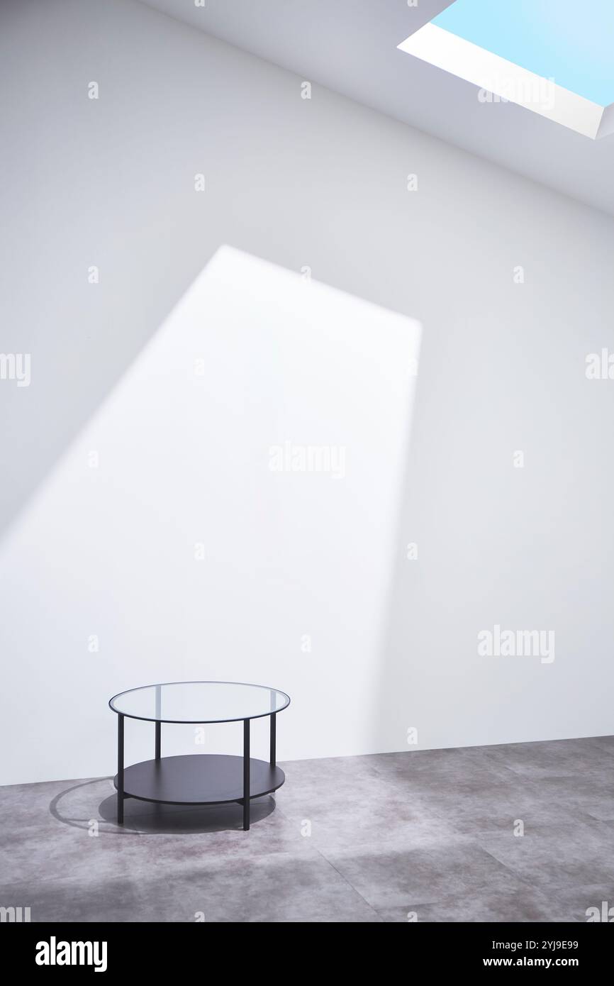Table in a room with sunlight through a skylight Stock Photo - Alamy