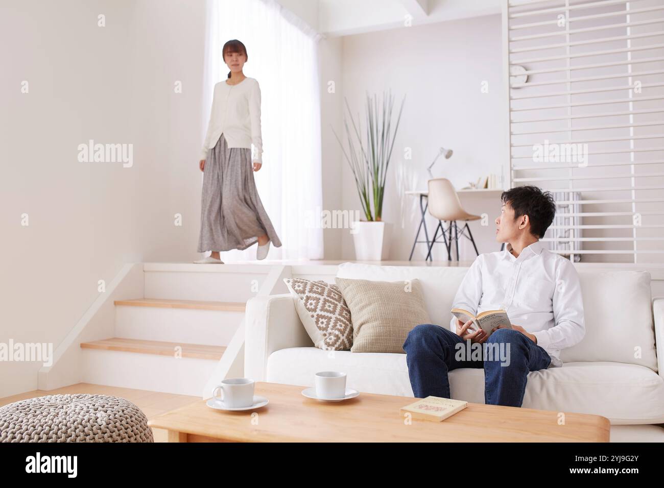 Man sitting woman walking table hi-res stock photography and images - Alamy
