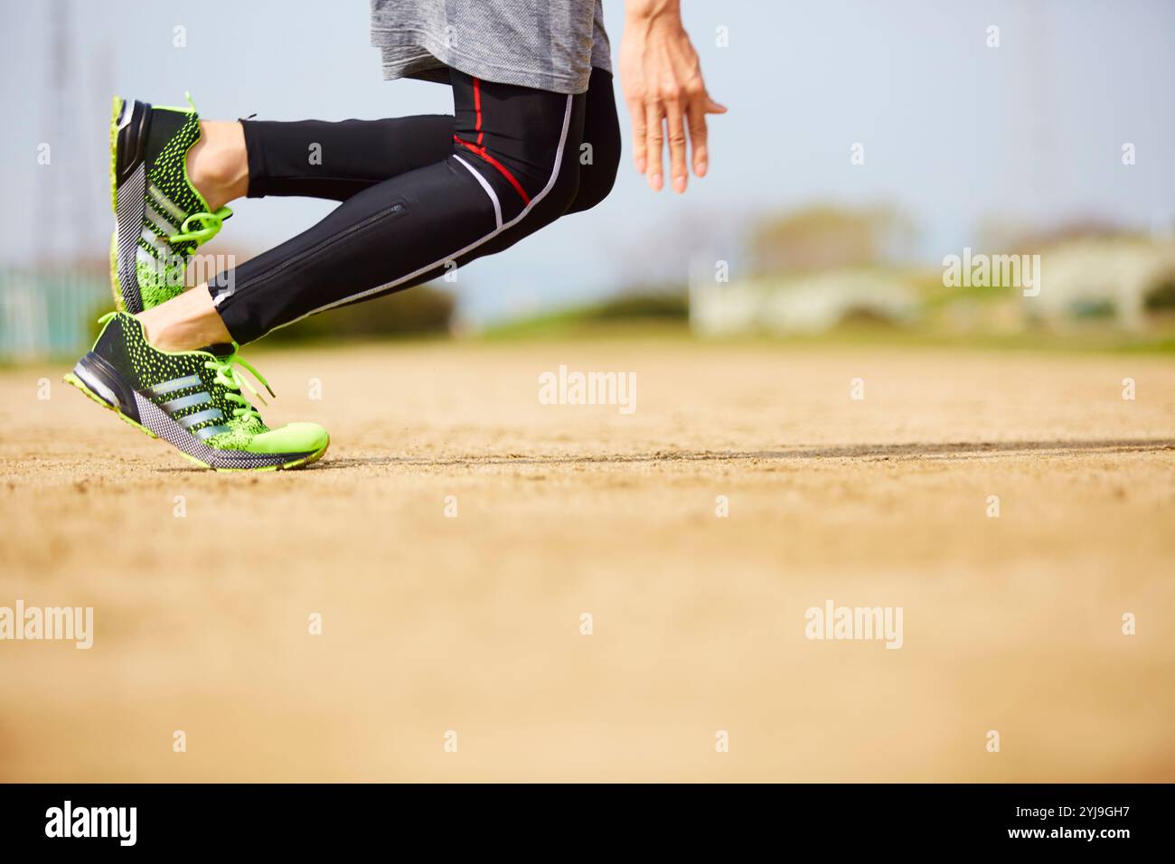 Sportsman's feet running on the ground Stock Photo - Alamy