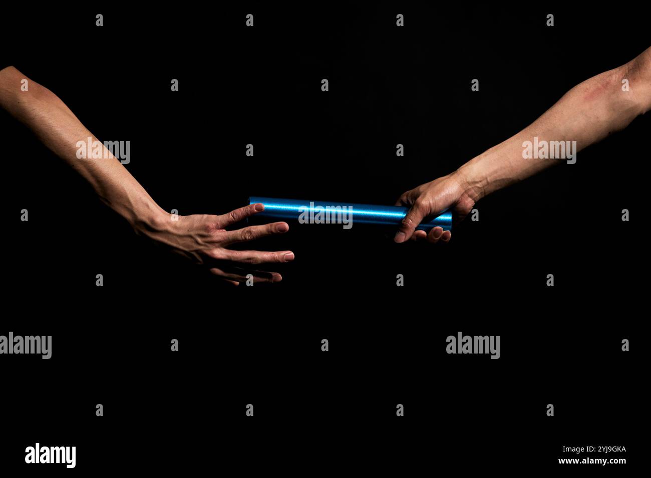 Male athlete passing the baton on black background Stock Photo - Alamy