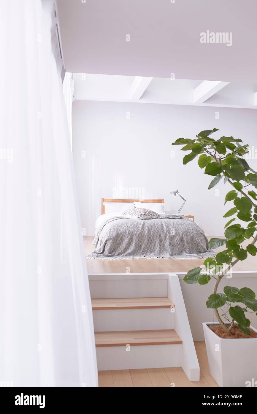 Simple bedroom with step floor Stock Photo - Alamy