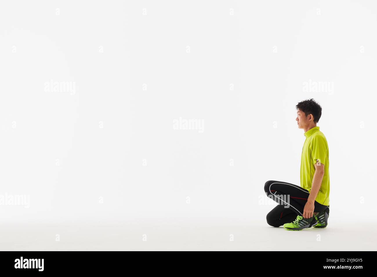 Male track and field athlete taking the starting position Stock Photo ...