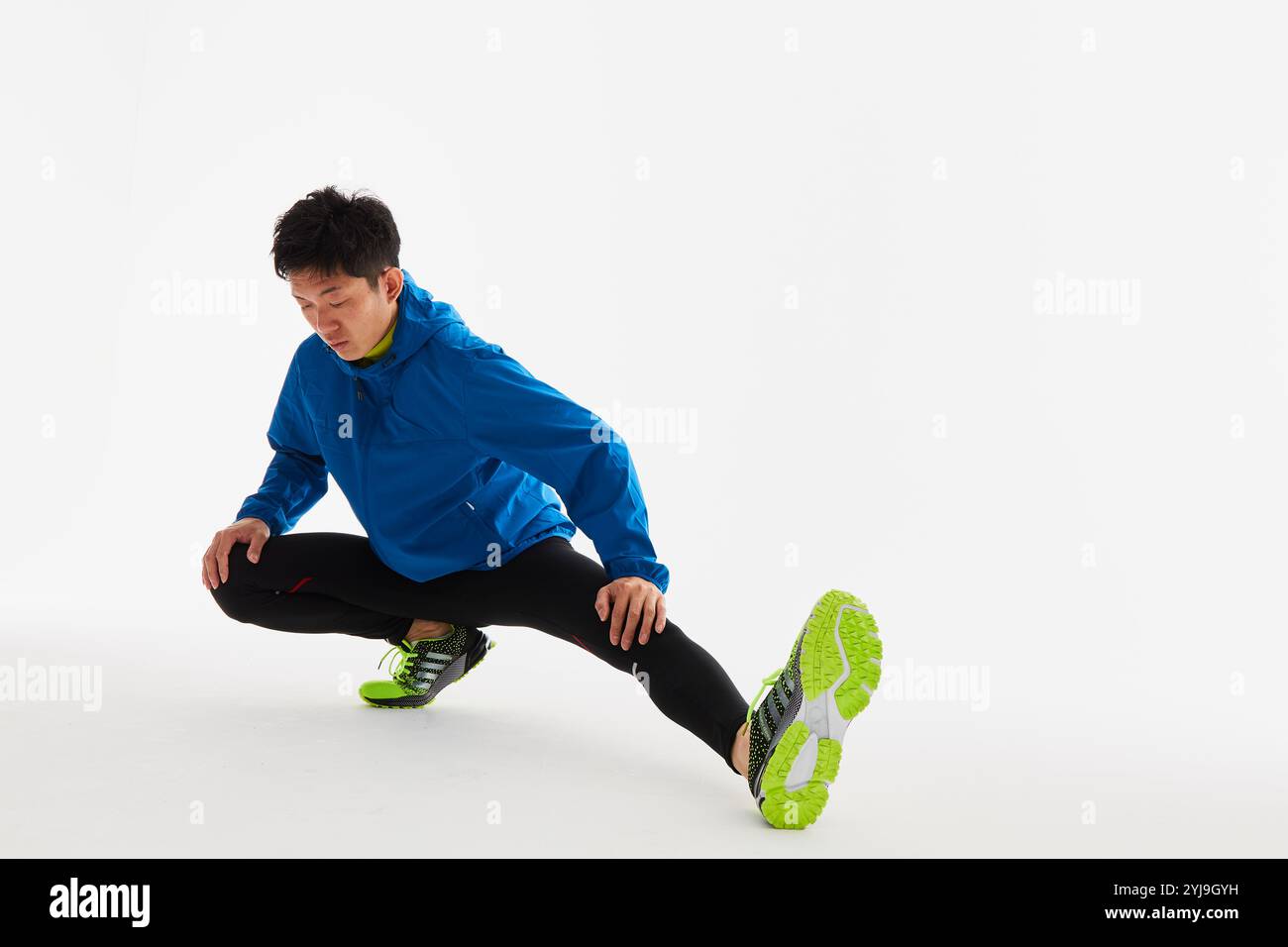 Male track and field athlete doing preparatory exercises Stock Photo ...