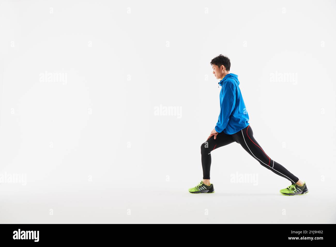 Male track and field athlete doing preparatory exercises Stock Photo ...