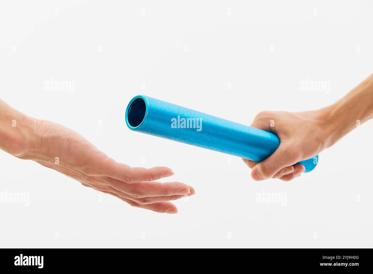 Male athletes passing baton in the hands of male athletes Stock Photo ...