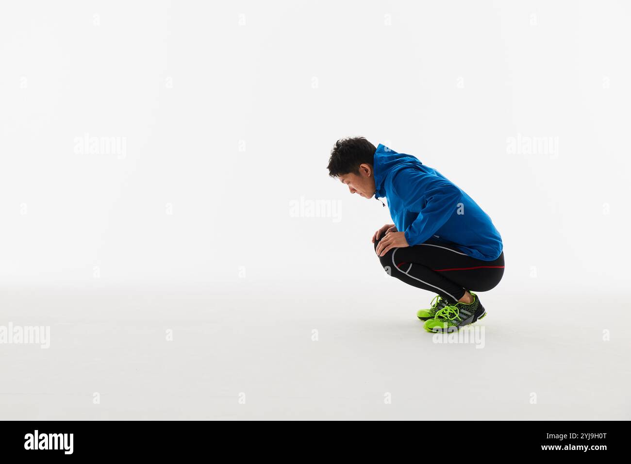 Male track and field athlete doing preparatory exercises Stock Photo ...