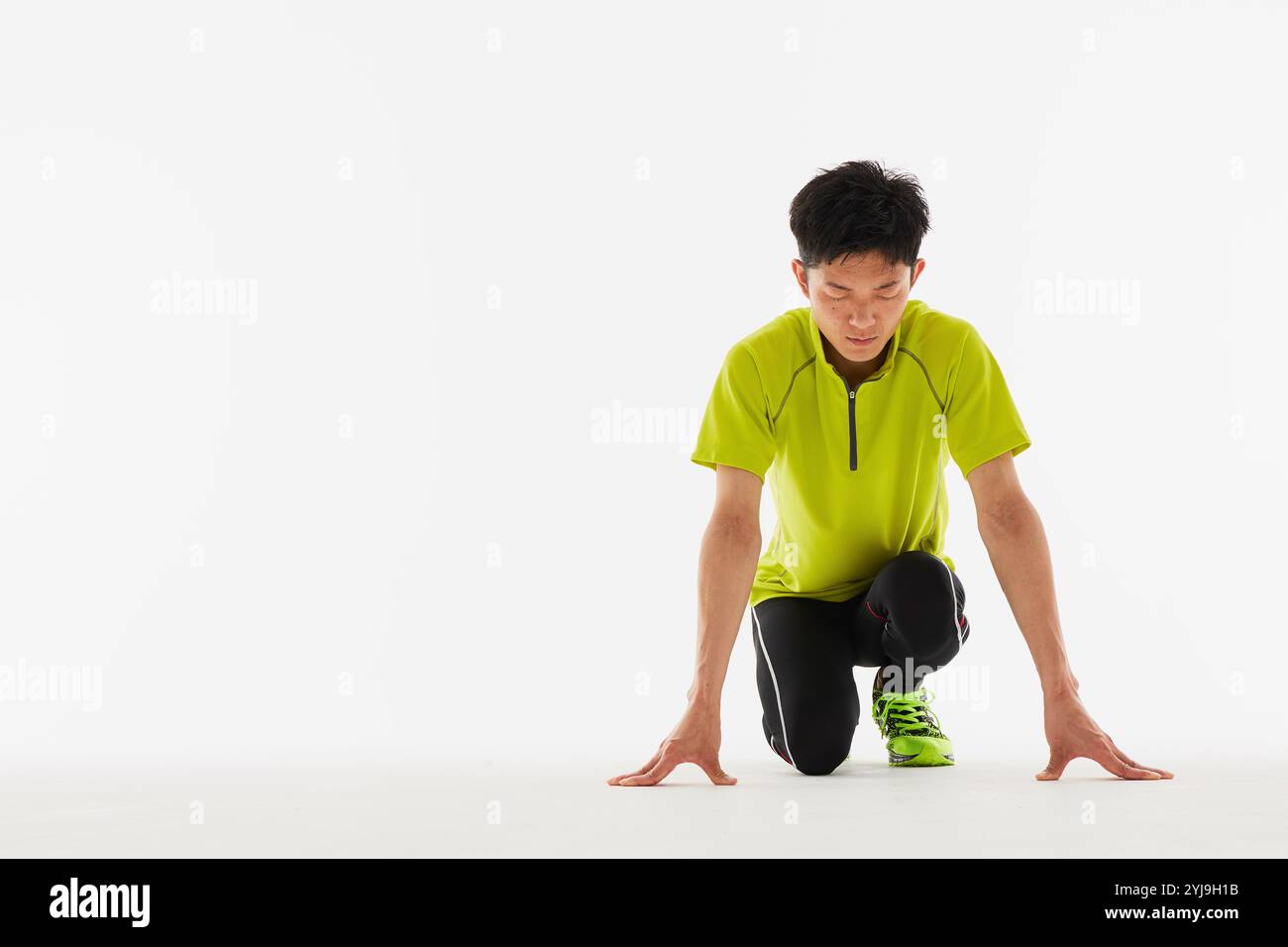 Male athlete taking the starting position and concentrating Stock Photo ...