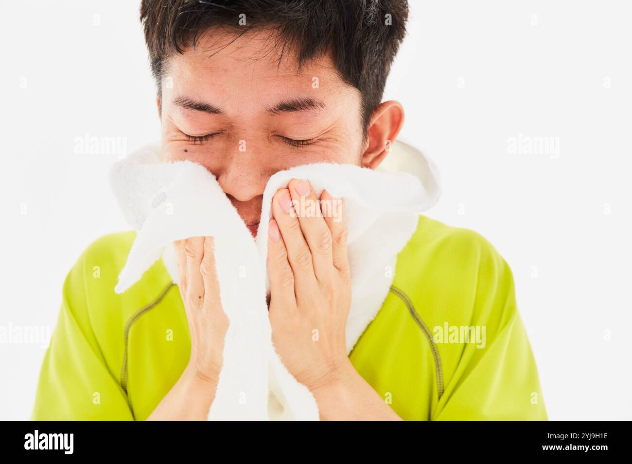 Man wiping sweat with towel Stock Photo - Alamy