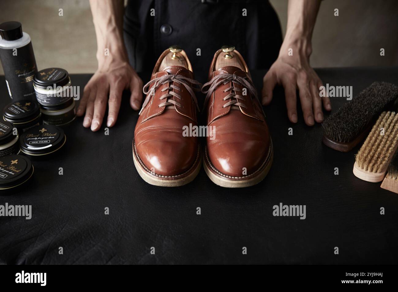 Craftsman's hand after repairing a shoe Stock Photo - Alamy