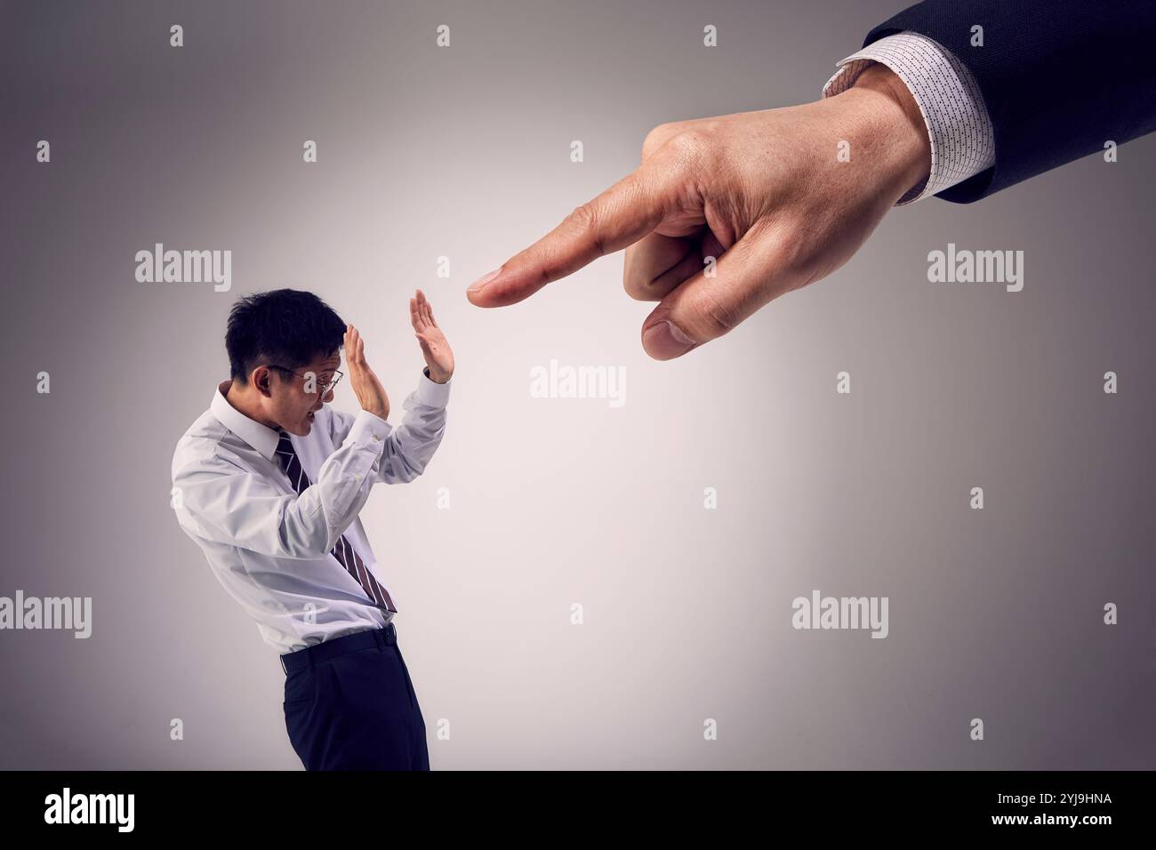 Male employee being overwhelmed by a large hand pointing at him Stock ...