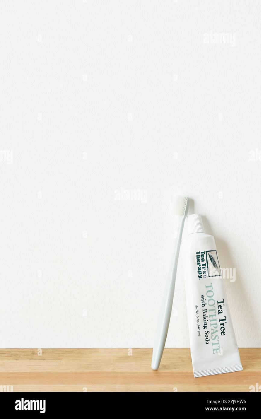 Toothbrush and toothpaste against white wall Stock Photo - Alamy