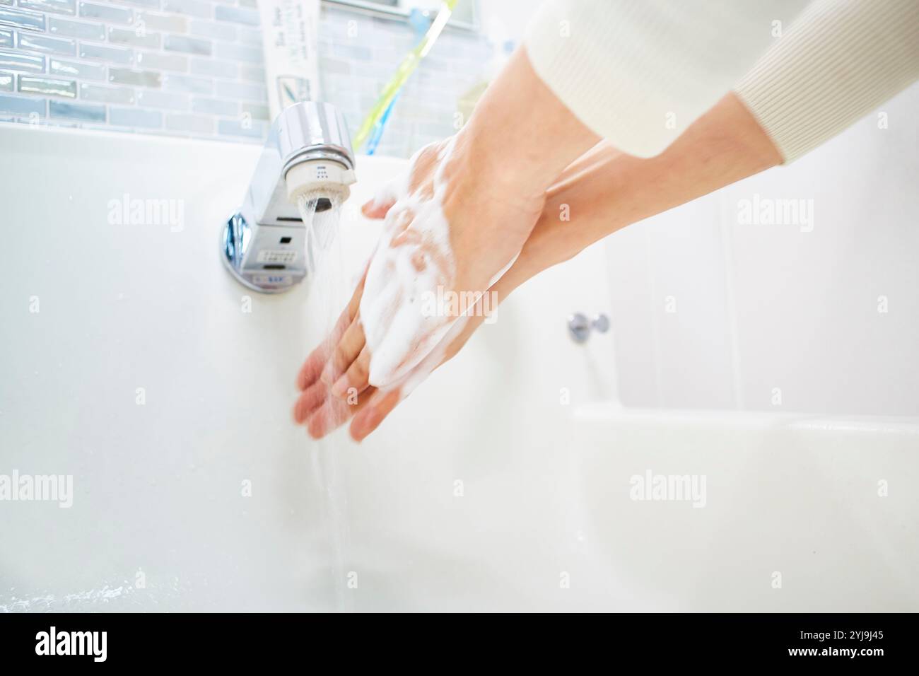 Woman washing her hands in the washroom Stock Photo - Alamy