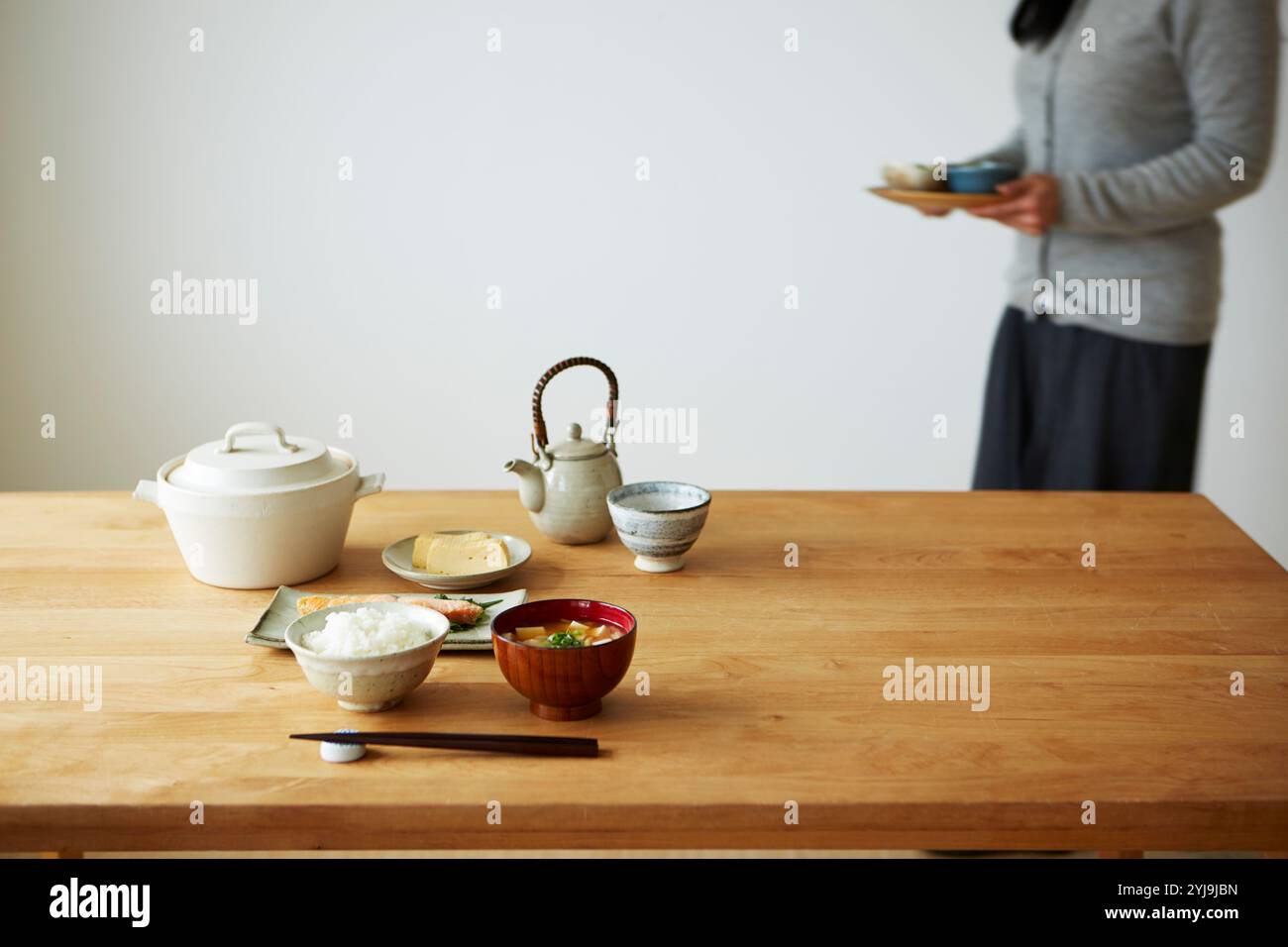 Woman carrying tray to table Stock Photo - Alamy