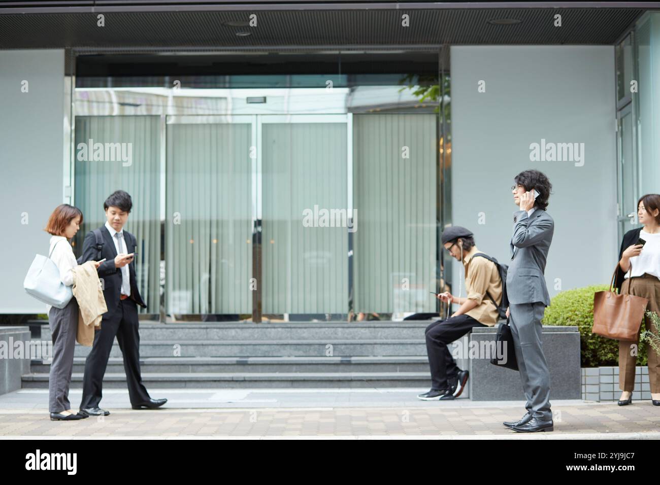 People touching their smartphones in business street Stock Photo - Alamy