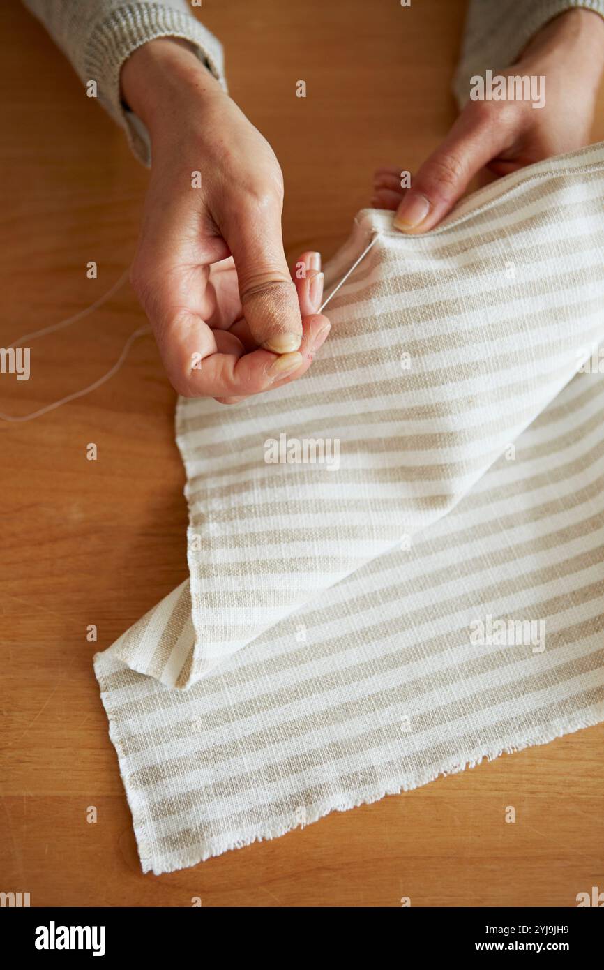 Hand of a woman sewing Stock Photo - Alamy