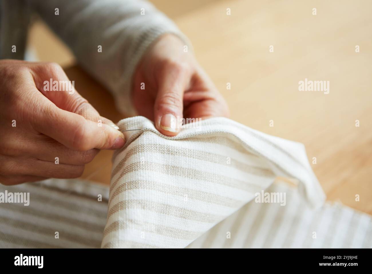 Hand of a woman sewing Stock Photo - Alamy