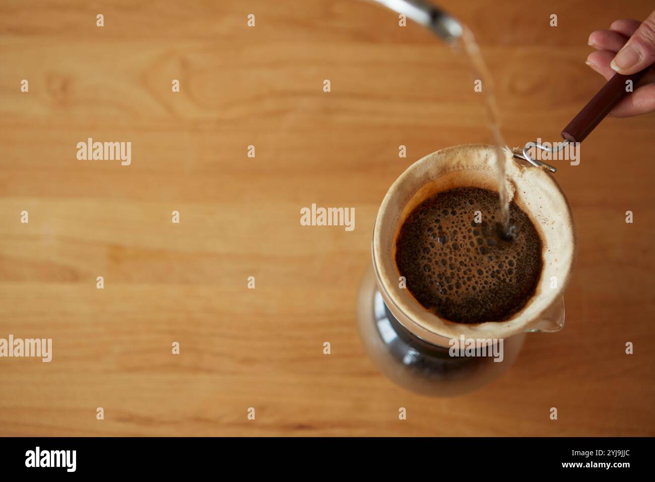 Pouring hot water into coffee beans Stock Photo - Alamy