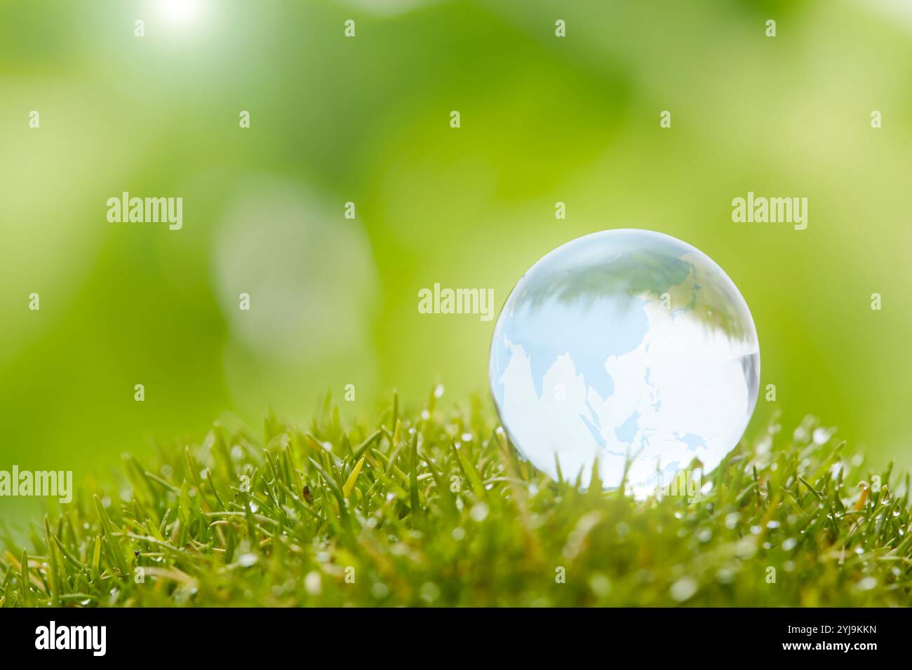 Glass globe on green Stock Photo - Alamy