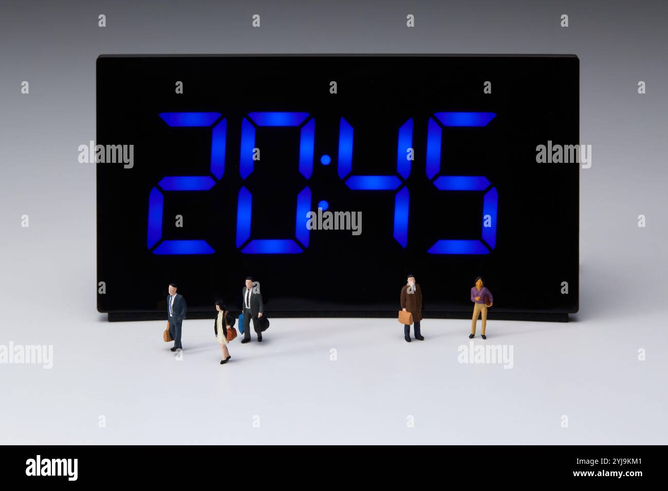 Digital clocks and miniature people Stock Photo - Alamy