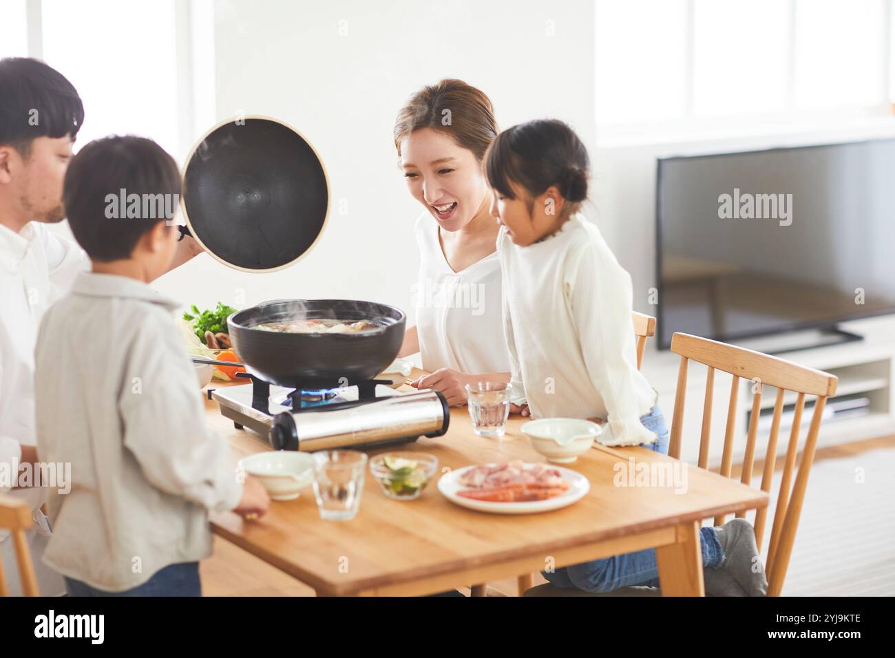 Family eating a nabe dish Stock Photo - Alamy