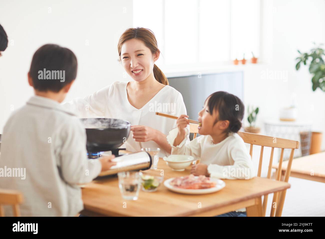 Family eating a nabe dish Stock Photo - Alamy