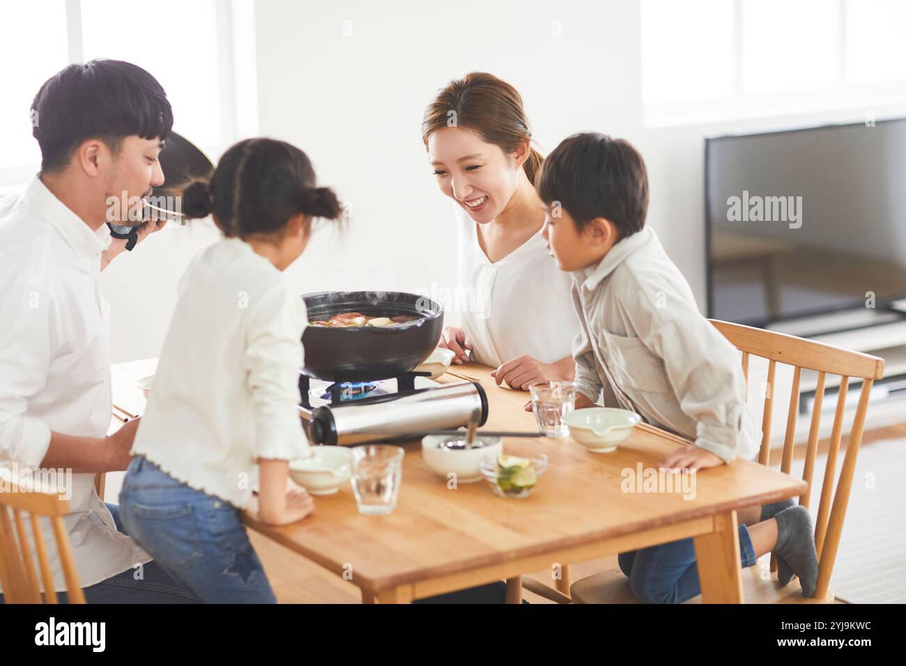 Family eating a nabe dish Stock Photo - Alamy
