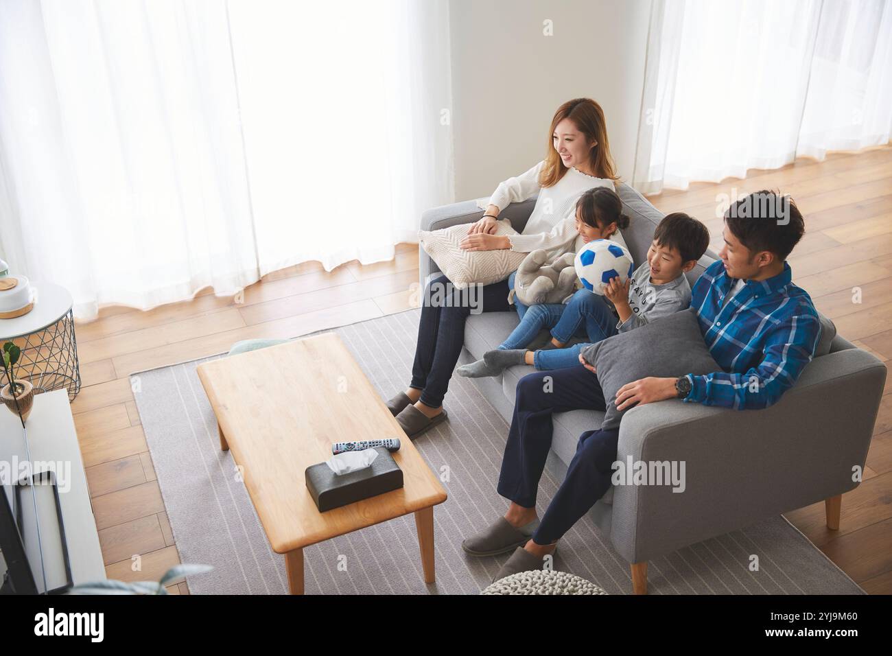 Family enjoying themselves in the living room Stock Photo - Alamy