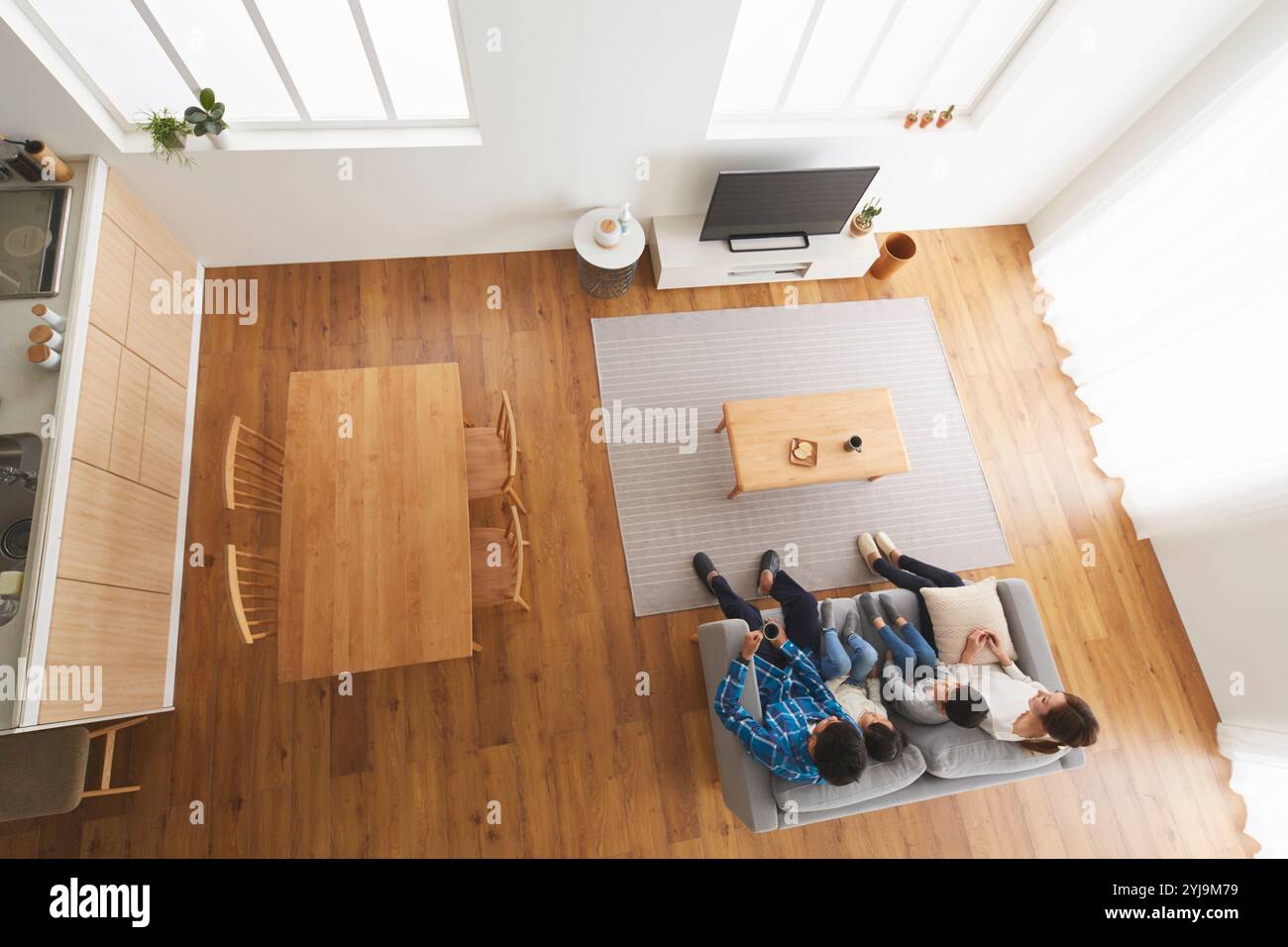 Family enjoying themselves in the living room Stock Photo - Alamy