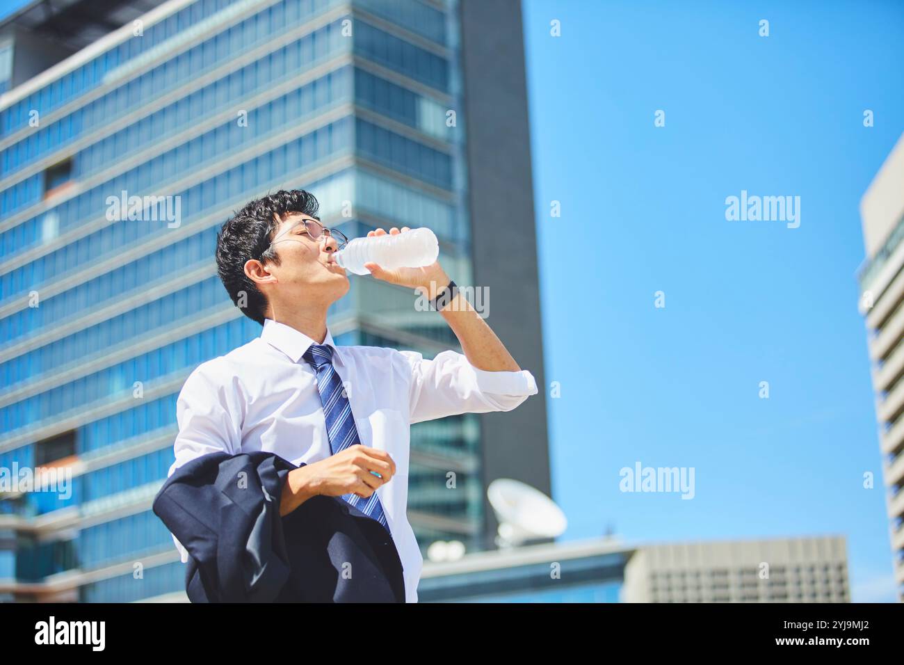 Office worker rehydrating under the blazing sun Stock Photo - Alamy
