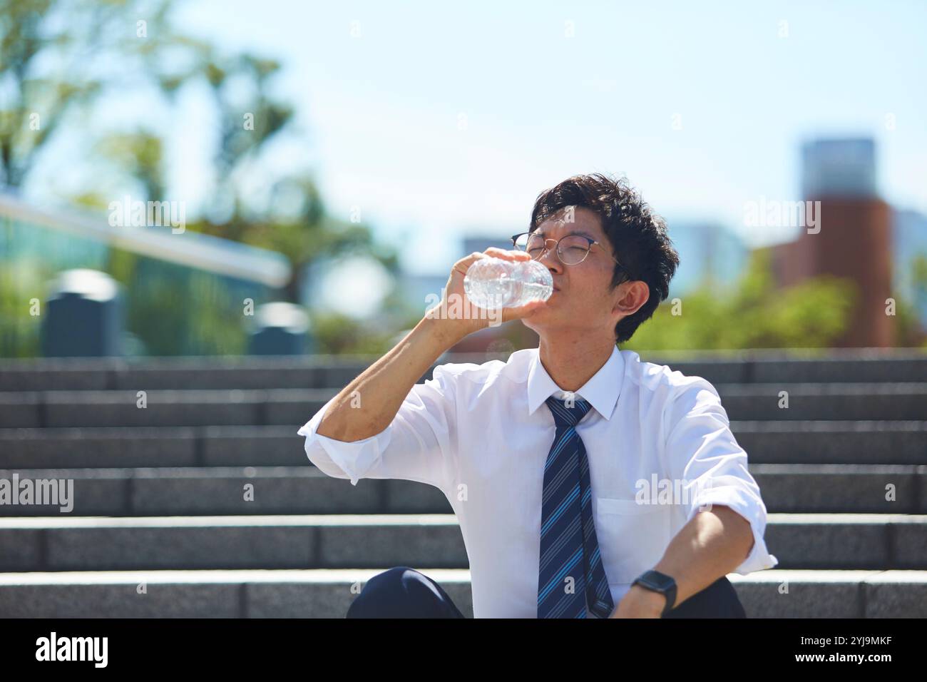 Office worker rehydrating under the blazing sun Stock Photo - Alamy